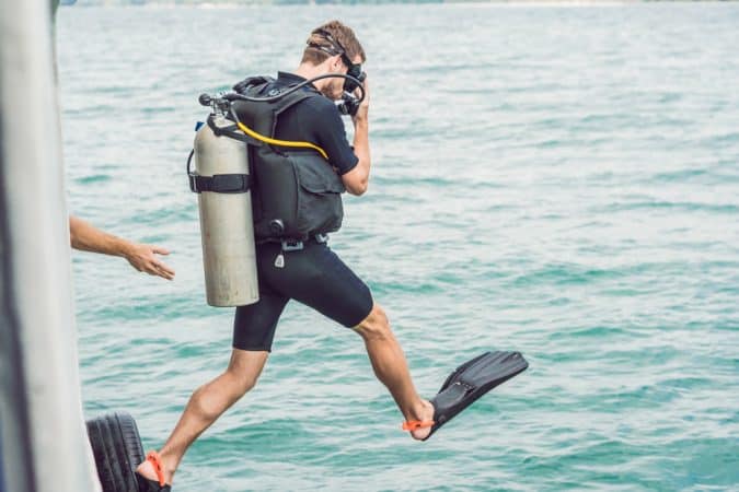 Why do Scuba Divers Dive Backwards into the Water? - Scuba Diving Gear